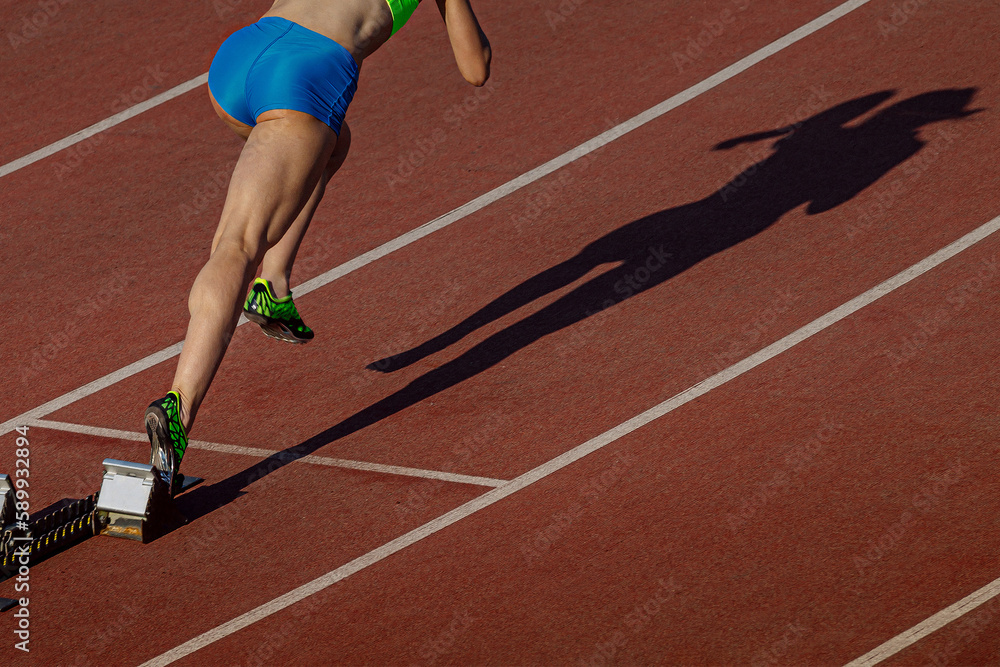 start female athlete from starting blocks running sprint distance ...