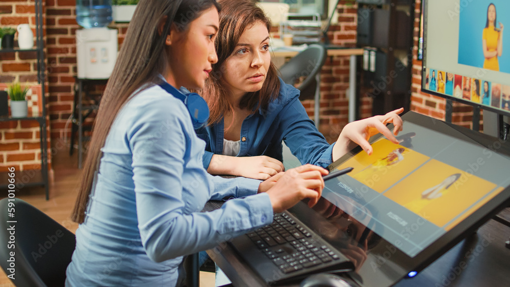 Team of photographers working on photography edit with touchscreen ...