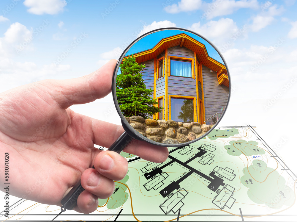 Country house. Hand holding magnifying glass over village map. Two ...