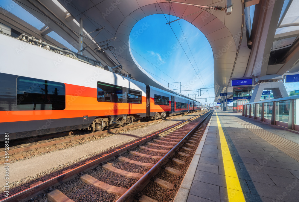 High speed train on the modern railway station at sunset in Graz ...