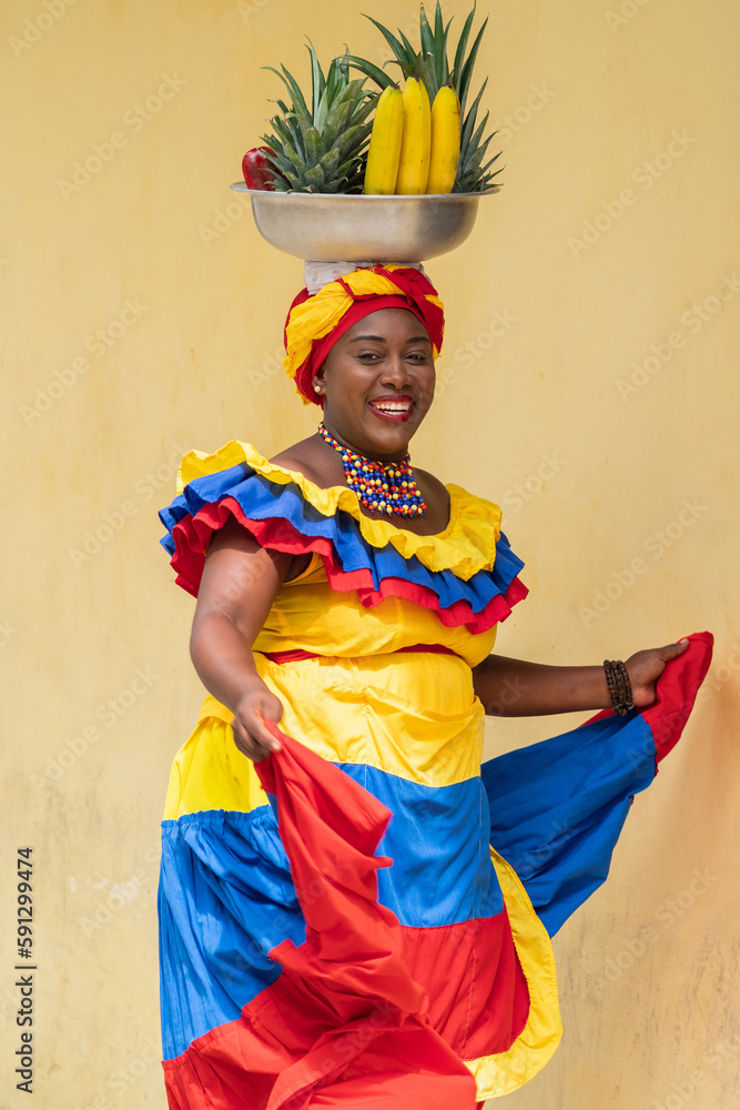 Cheerful fresh fruit street vendor aka Palenquera dancing in the Old ...