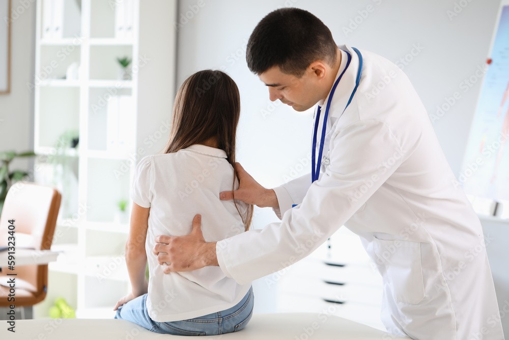Doctor checking posture of little girl in clinic Stock Photo | Adobe Stock