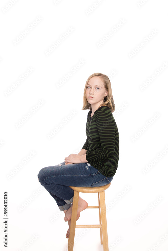 Pre-teen tween girl sitting alone isolated looking scared and confused ...