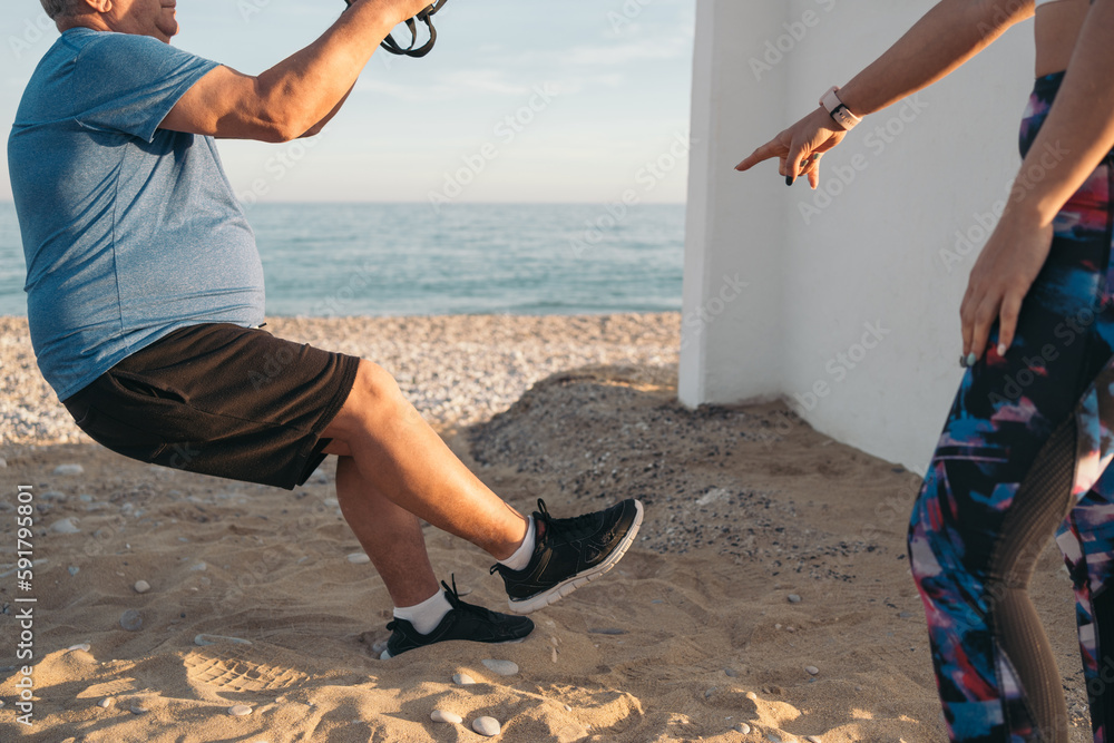 Стокове фото Young personal trainer indicating to an older white-haired ...