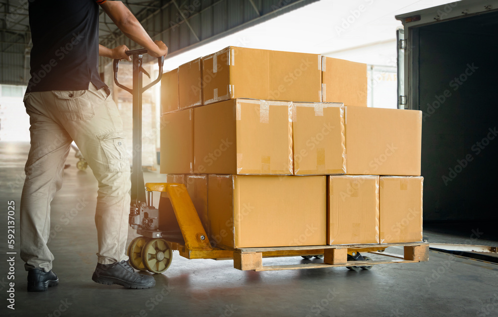 Workers Unloading Package Boxes on Pallets in Warehouse. Cargo Delivery ...