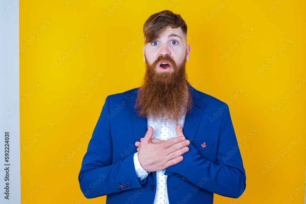 Foto de Stock Scared red haired man wearing blue suit over yellow ...
