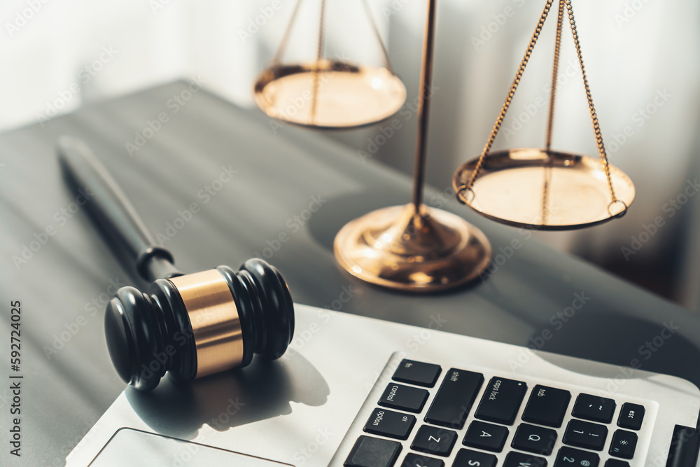 Symbolizing justice and legal authority, golden balanced scale and ...