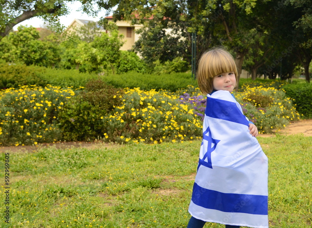 Little boy with the flag of Israel. A child in a blooming garden ...