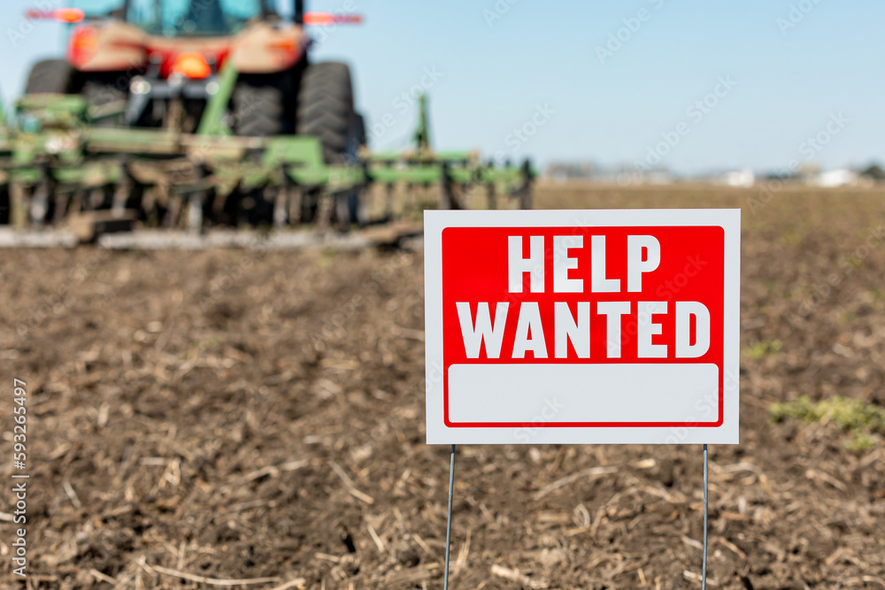 Help wanted sign in farm field during spring planting season. Farm ...