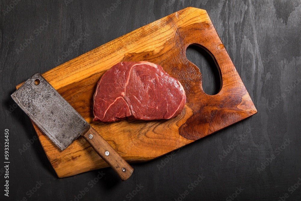 Raw rump beef cut or top sirloin meat steak on butcher table. Black ...