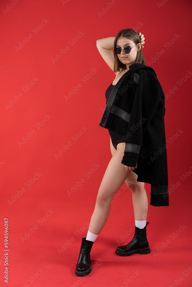 girl in a black bathing suit. Studio. Sexy woman in a black bodysuit ...