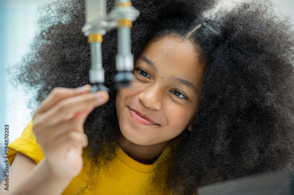 Kid female teen child enjoy Machine Learning Robot arm is Moving Under ...