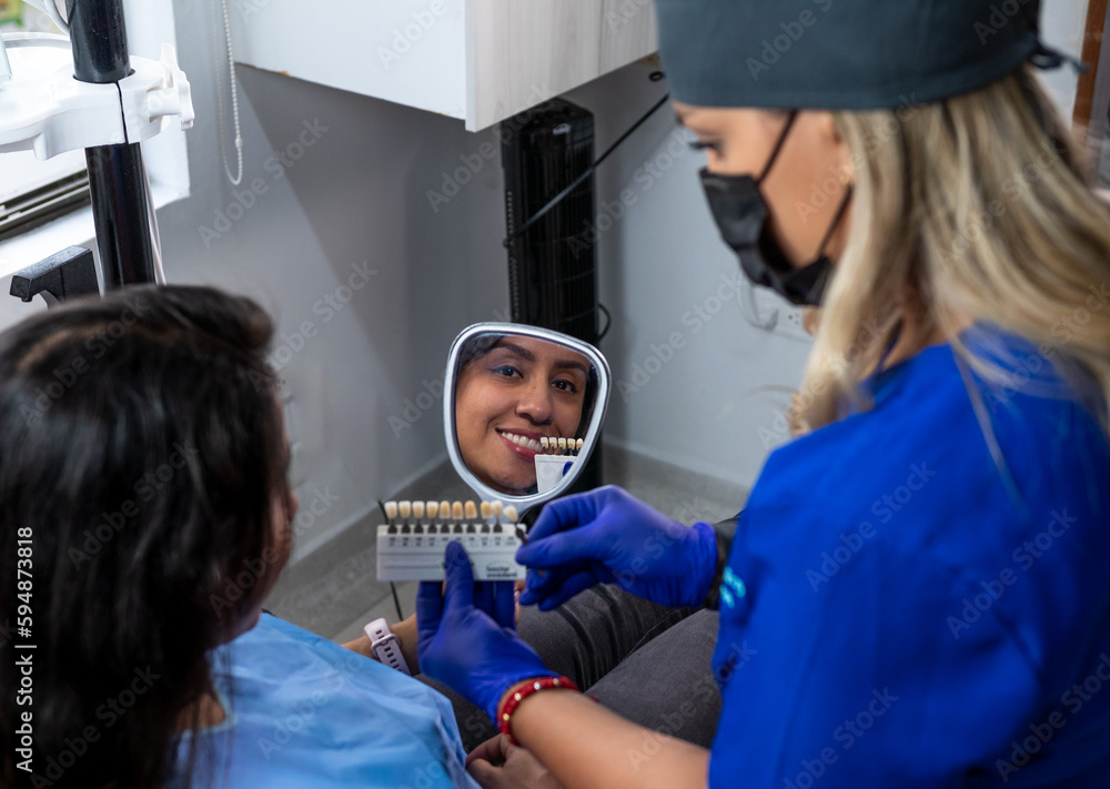 Odontologist Showing Tooth Color Chart to Patient in Exam Room Stock ...