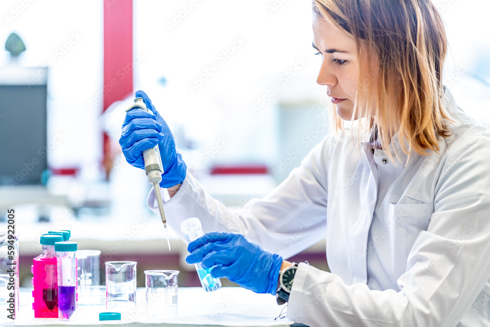 mixing of chemical substances by a young female scientist in a ...