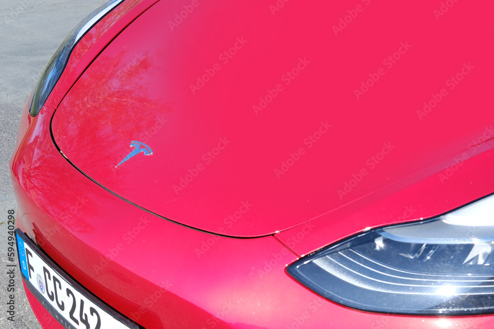 red Tesla car model Y in Metallic color on street, electric vehicle in ...