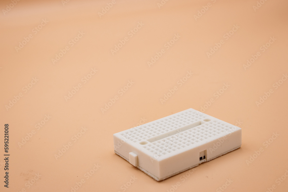 White mini breadboard isolated on background. Close up. Stock Photo ...