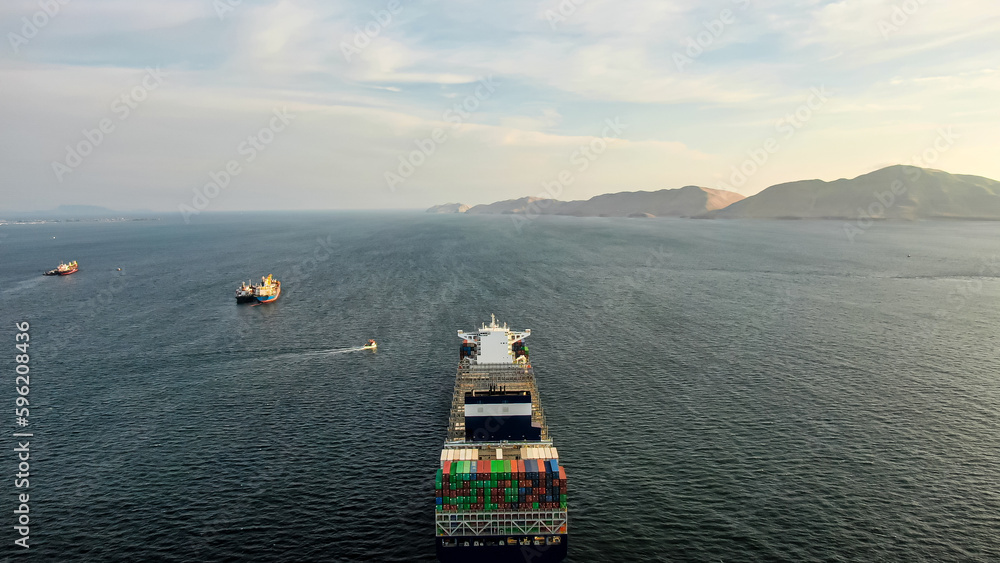Aerial view of blue hull color ultra large container ship in discharged condition at anchor near ...