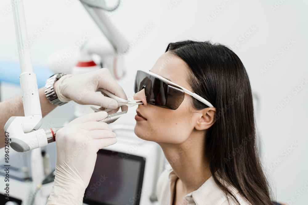 Photo Stock Laser treatment of chronic rhinitis. ENT doctor with laser ...