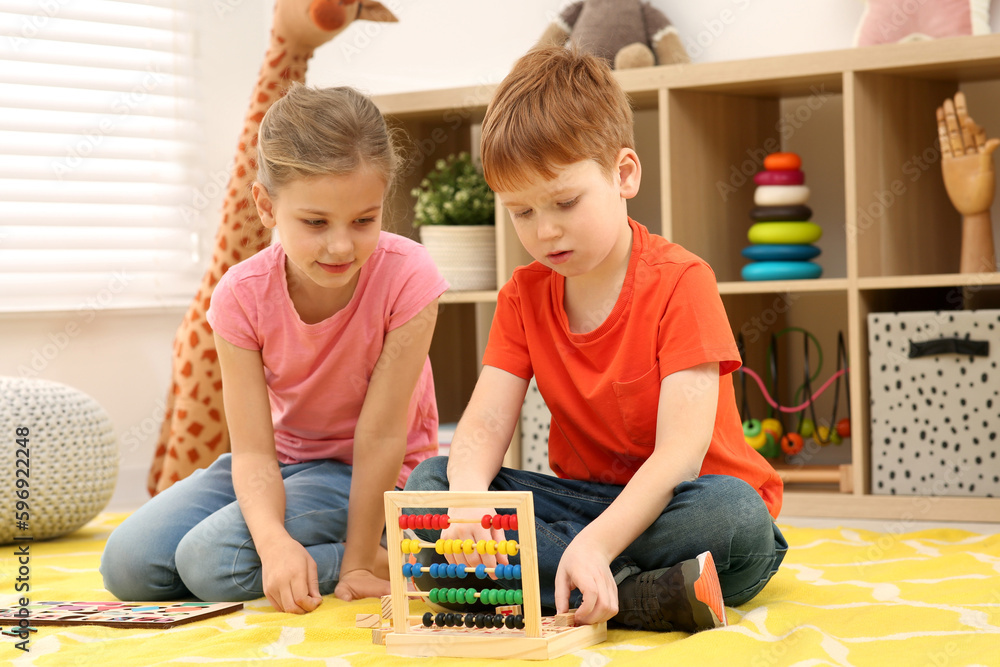 Foto de Stock Children playing with math game kit on floor in room. Learning mathematics with ...