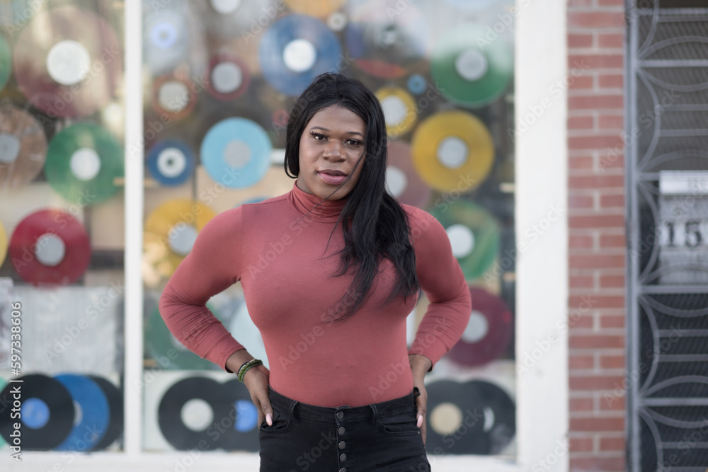 Wearing a sleek, long-sleeved turtleneck, a model expresses a power ...