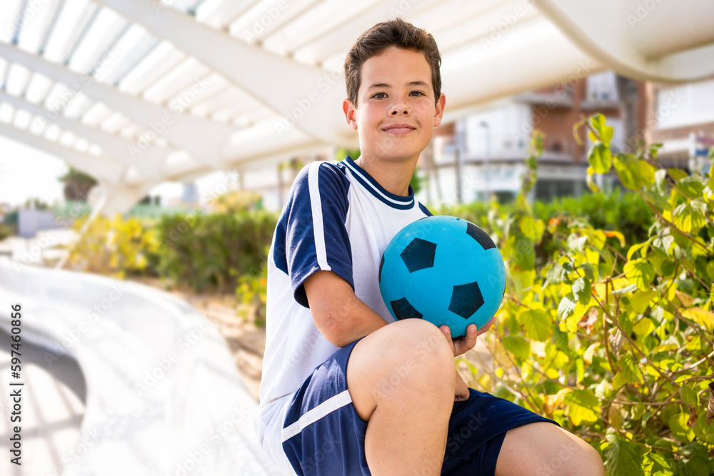 Cheerful preteen boy enjoy soccer, football sport games. Boy holding ...