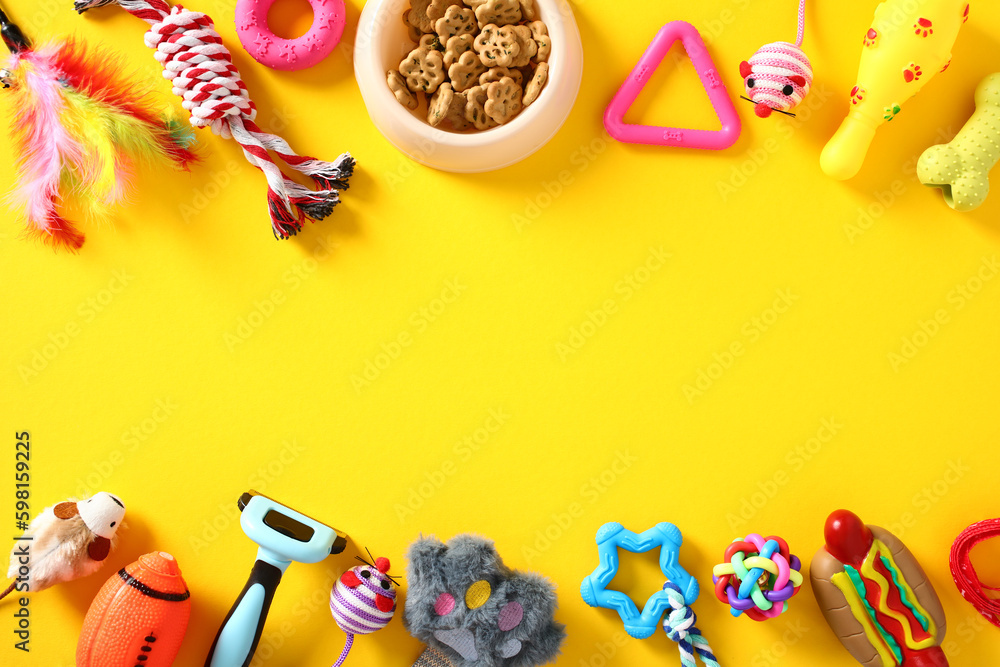 Frame of different pet toys and training accessories on yellow ...
