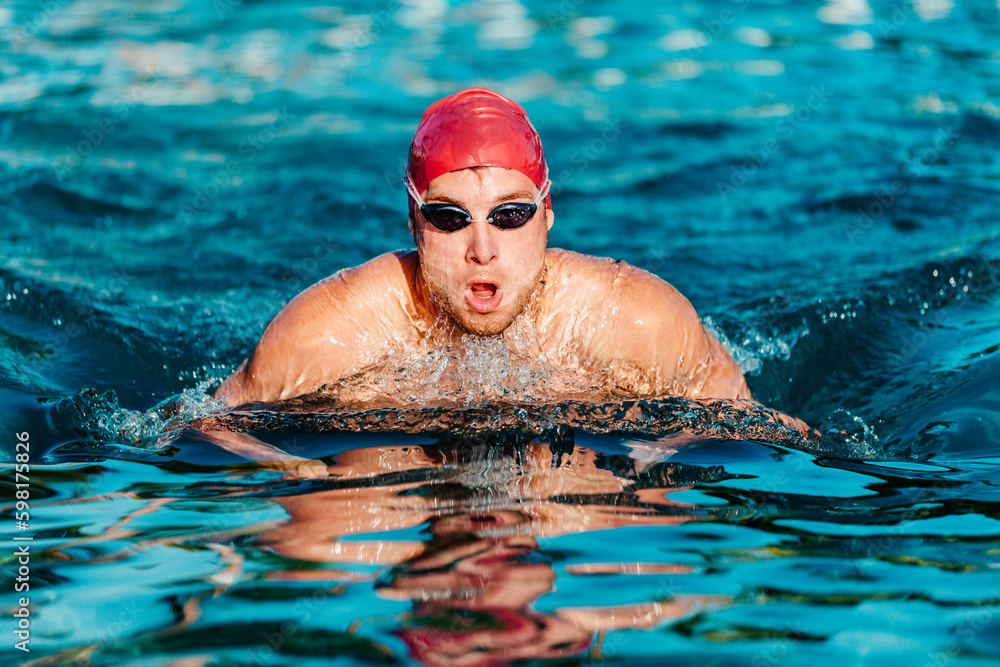 Swimming man - male swimmer swimming breaststroke. Portrait of man ...