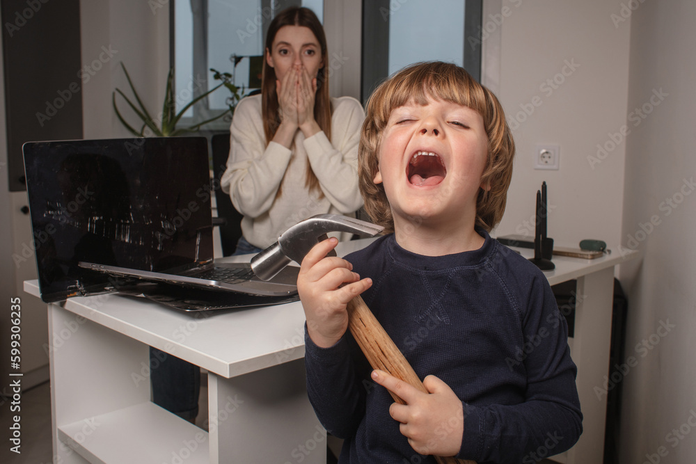 Happy child smashes mom's work laptop to spend more time together. The ...