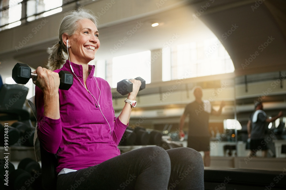Live, laugh, love, lift. Portrait of a happy senior woman working out ...