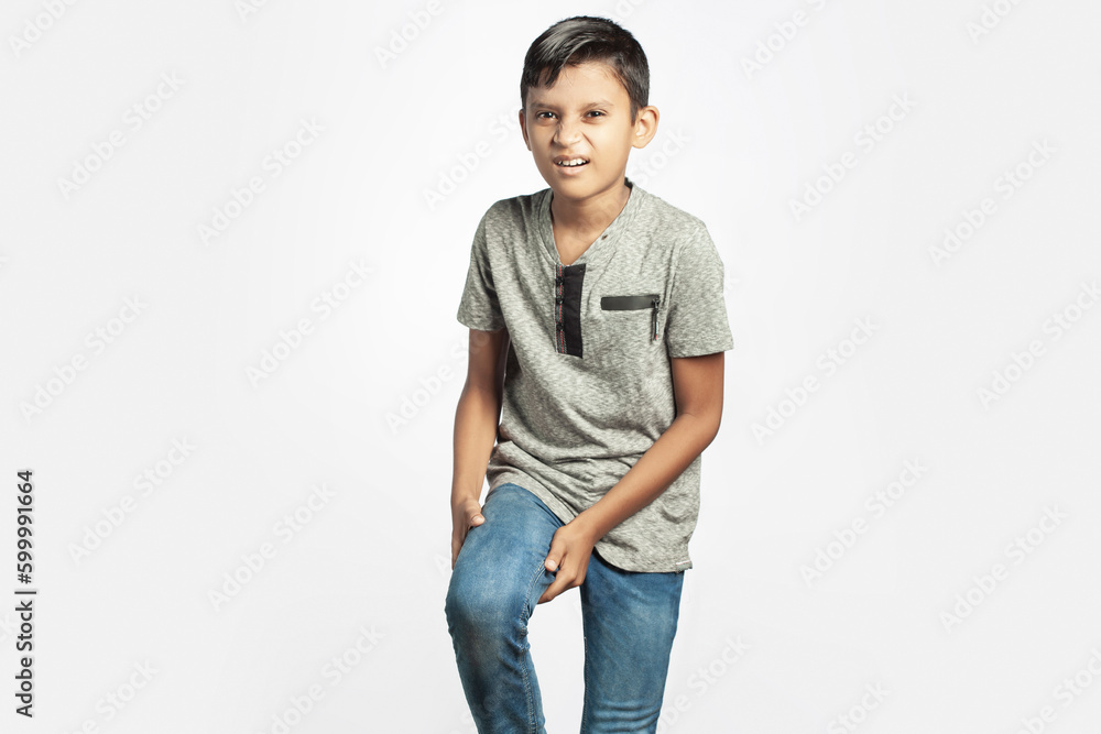thigh muscle pain, boy touching his painful injured thigh in white ...