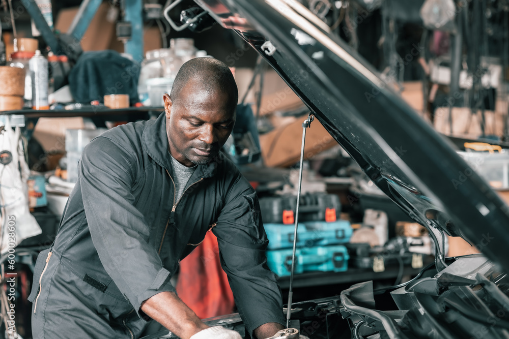 Experienced auto mechanics inspect car battery terminals and voltage to ... Experienced auto mechanics inspect car battery terminals and voltage to ...