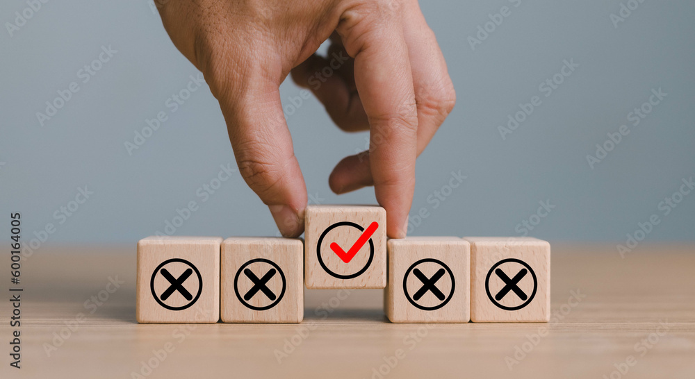 Checkmark and cross icons on wooden cubes on white background ...