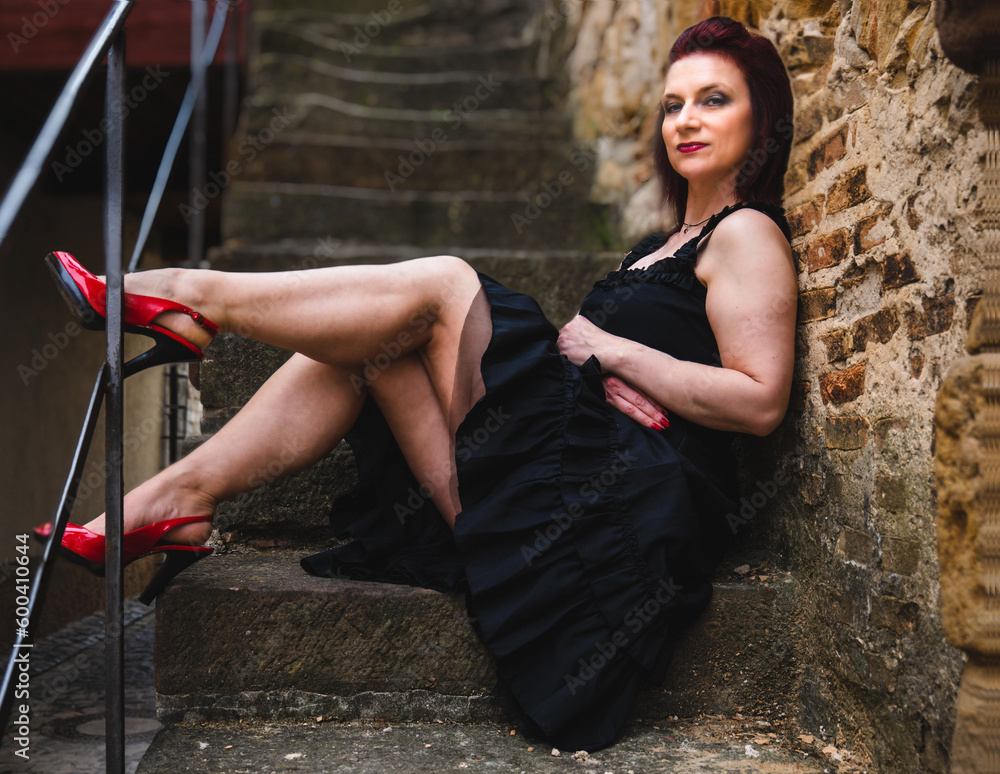 sexy mature woman in red high heels and skirt on a staircase Stock Photo | Adobe Stock