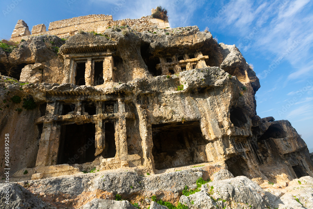 View of antique rock burial chambers in ancient Lycian city of Tlos in ...