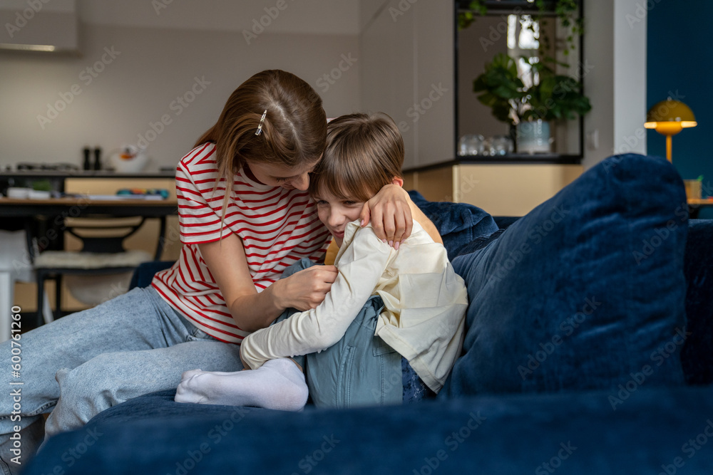 Affectionate empathic caring young mom hugging upset or grieving teen ...