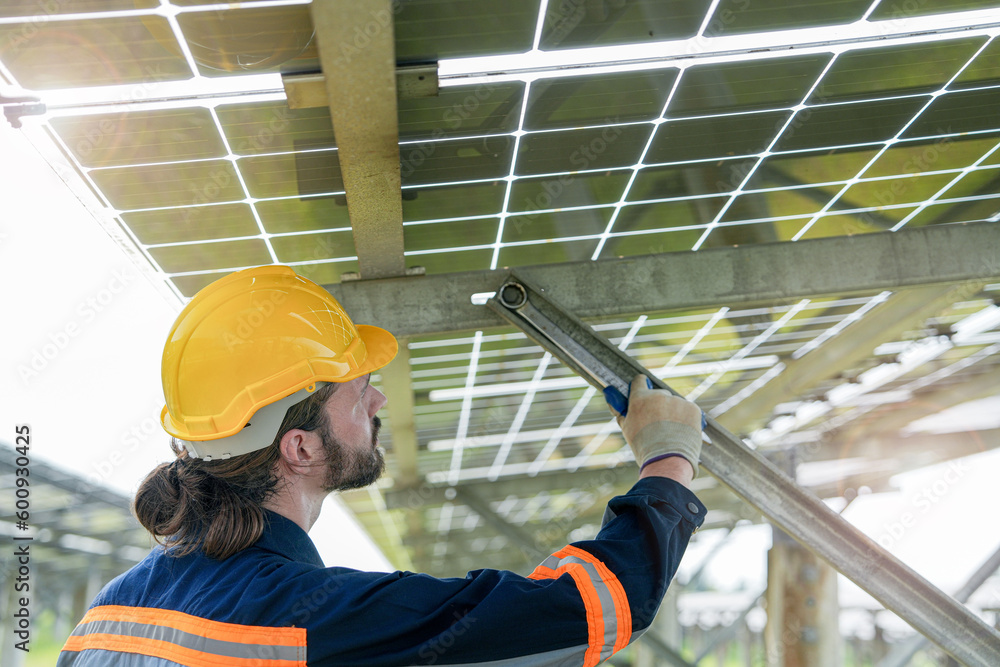 Factory engineer man checking and repairing solar panel construction ...