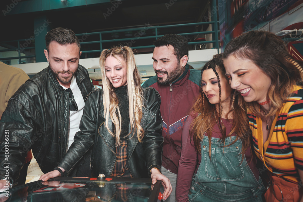 Fun Arcade Experience - Blonde girl with freckles plays pinball as her ...