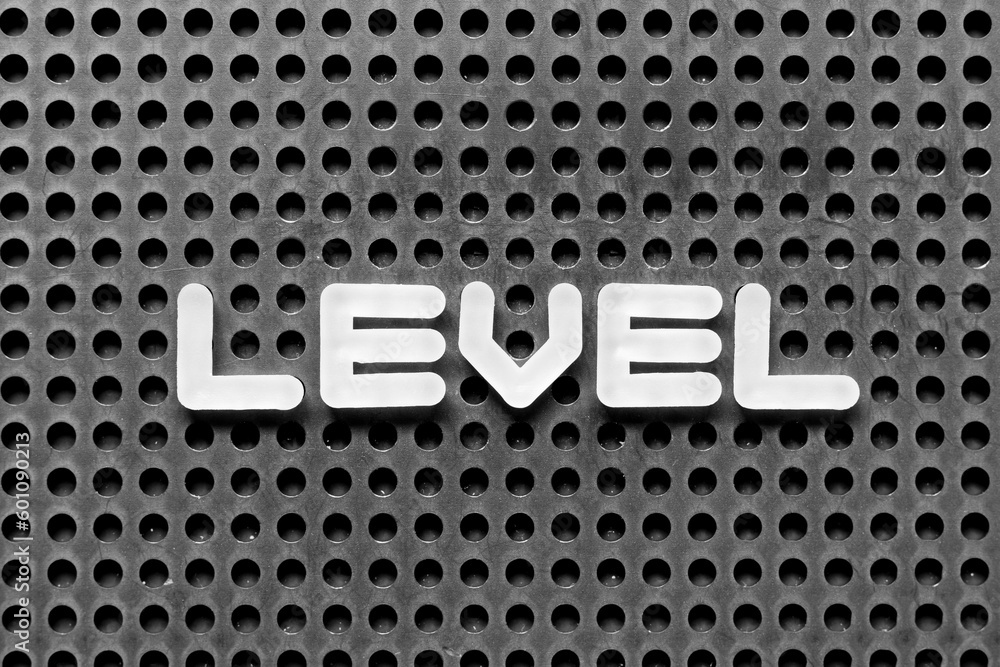 White alphabet letter in word level on black pegboard background Stock ...