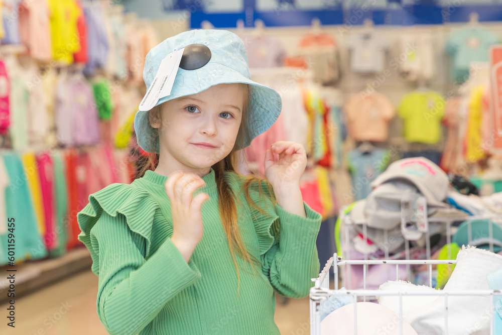 Cute Little Girl Picking her Own Clothes in Fashion Store. Toddler ...