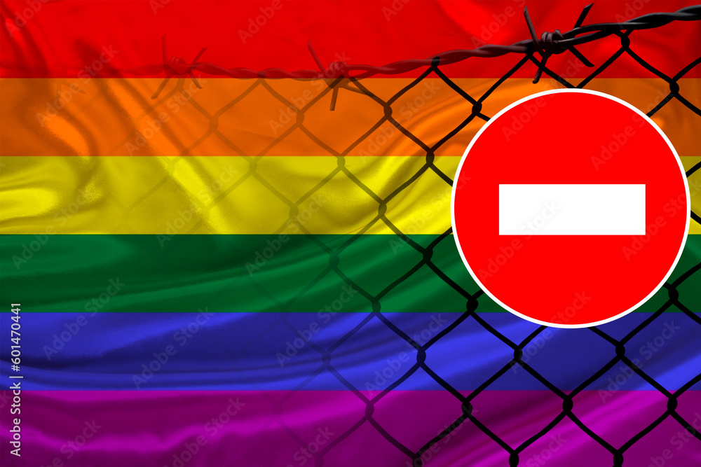 LGBT rainbow flag on satin, fence with barbed wire, symbolic red sign ...