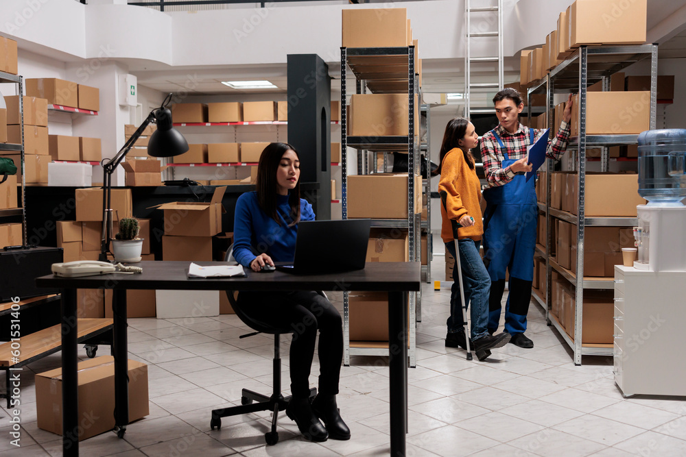 Warehouse employees managing customer order picking and packing in ...
