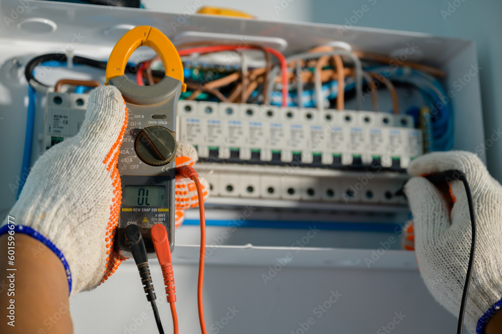 Electrical measurements with a multimeter tester. industrial ...