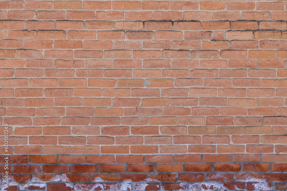 Full frame texture background of an antique exterior red brick wall with salt deposits from ...