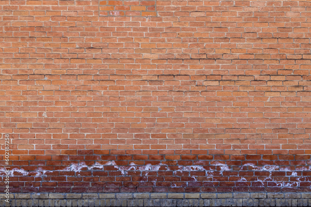 Full frame texture background of an antique exterior red brick wall with salt deposits from ...