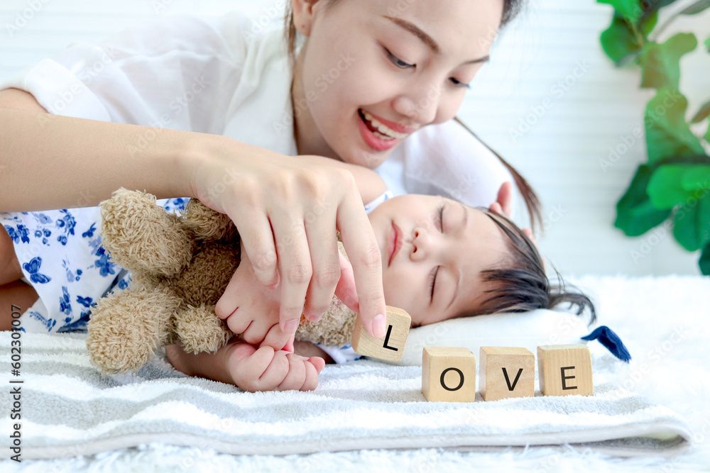 Beautiful mother hand hold text wooden blocks spelling the word LOVE ...