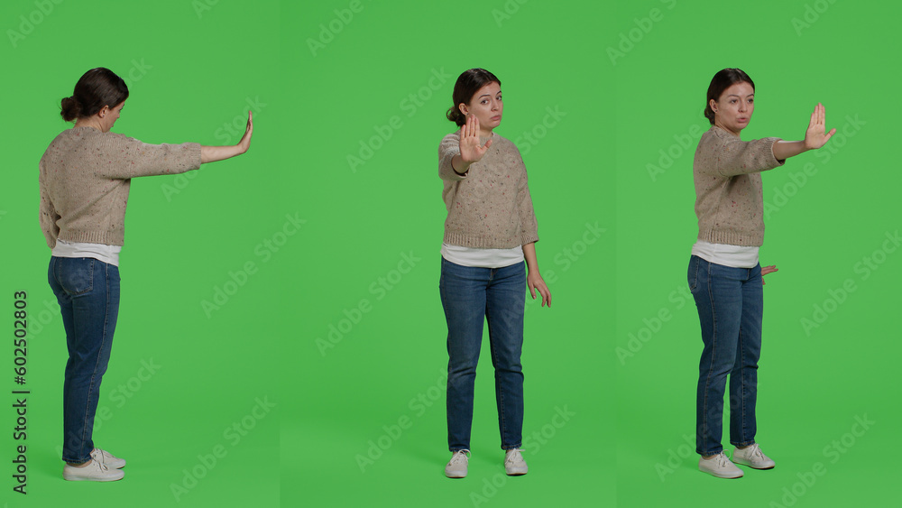 Female model showing palm over greenscreen background, full body of ...