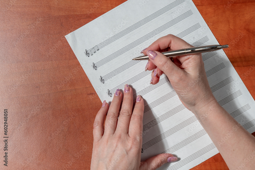 Handwritten notes and a treble clef. A sheet of paper with notes. Women ...