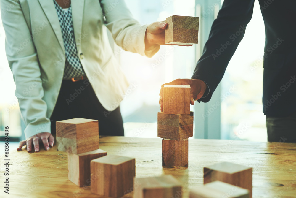 Teamwork, man and woman in office with building blocks, design ideas ...