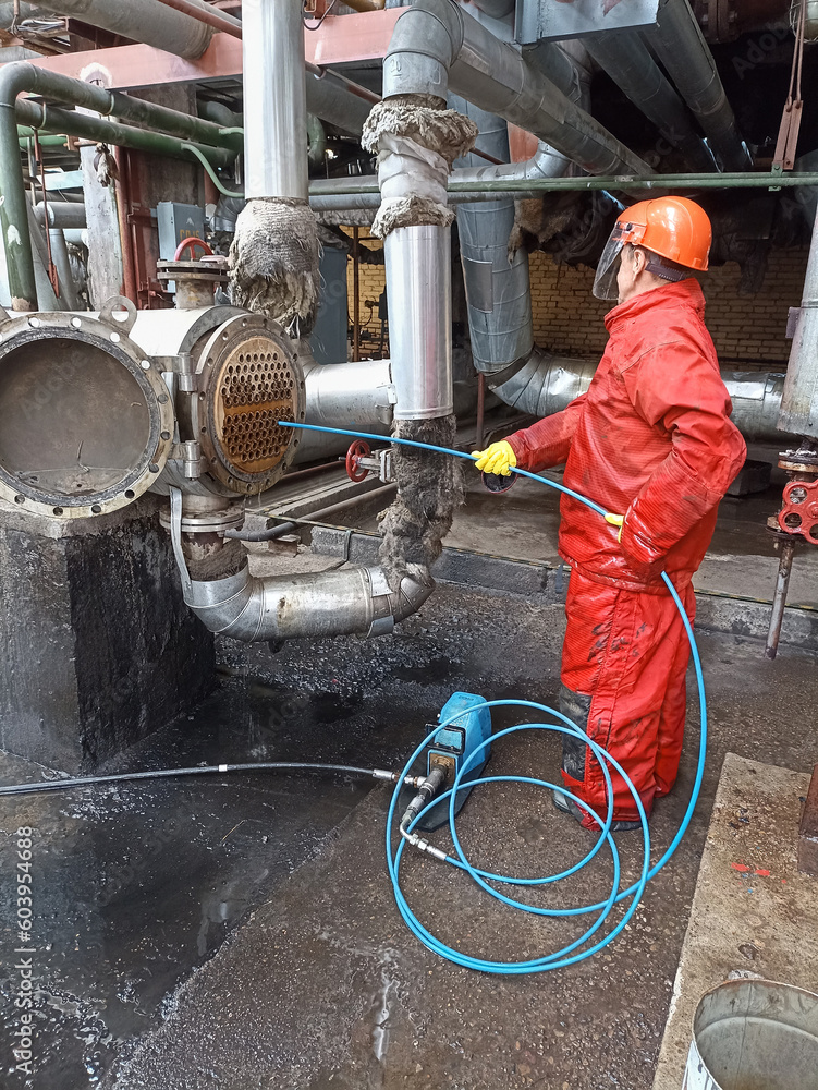 Man cleaning condenser tubes removing scales of petrochemical ...