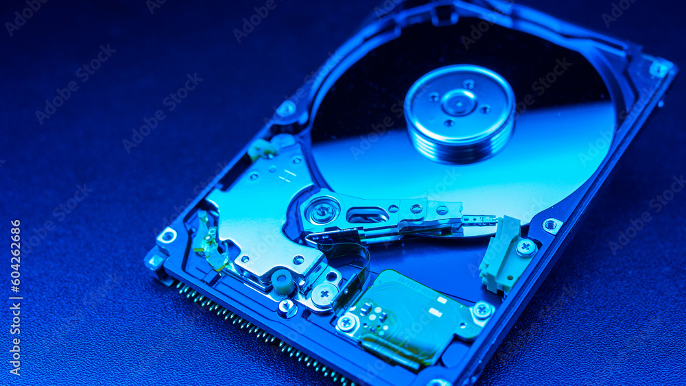 An open hard disk disassembled HDD of a computer or laptop lies on a ...